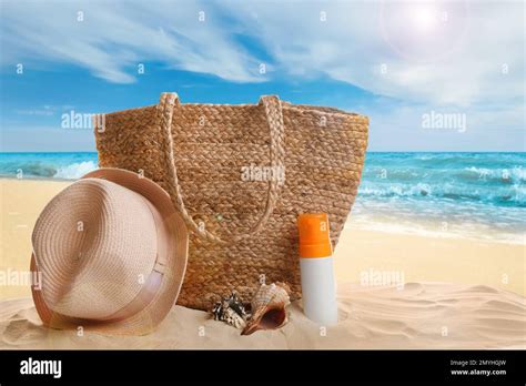 Different beach accessories on sand near ocean Stock Photo - Alamy