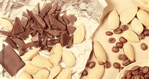 орехи миндаль шоколад и кофе лежат на столе Stock Photo | Adobe Stock