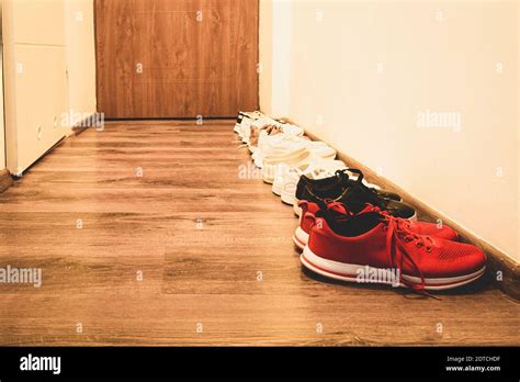 Family shoes at the front door. Big sports family Stock Photo - Alamy