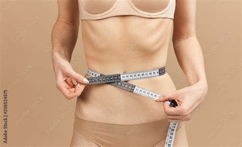 Mid waist portrait of undressed underweight caucasian female model ...