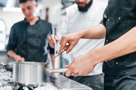 Group of people cooking food at kitchen together. Busy day at work ...