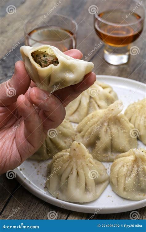 How To Eat Georgian Khinkali Dumplings Stock Photo - Image of bite ...