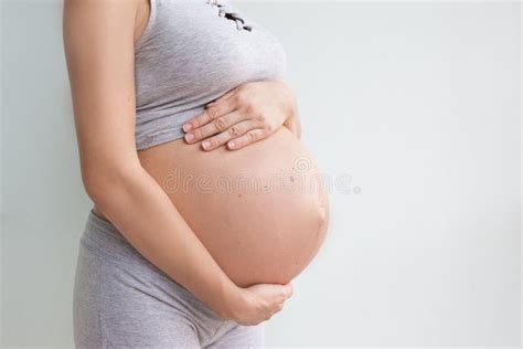 Close-up of a Pregnant Belly. a Pregnant Woman Holds Her Hands in Her ...