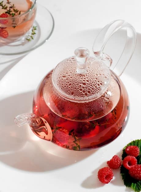 Premium Photo | Red herbal berry tea with thyme and fresh raspberry in ...