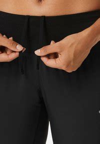 ASICS RACE - Tracksuit bottoms - performance black/black - Zalando.ie