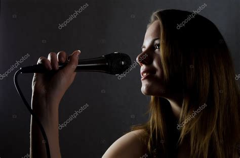 The girl with a microphone Stock Photo by ©voronin-76 7713629