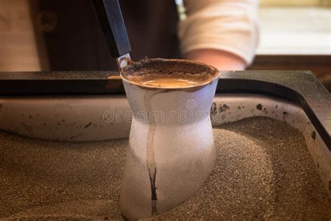 Preparing Coffee in Coffee Jezva in Sand. Turkish Method of Preparing ...