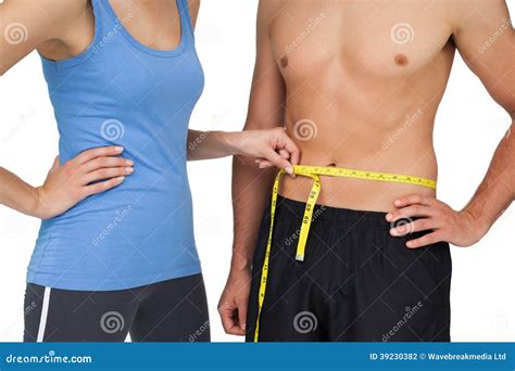 Mid Section of a Fit Woman Measuring Mans Waist Stock Photo - Image of ...