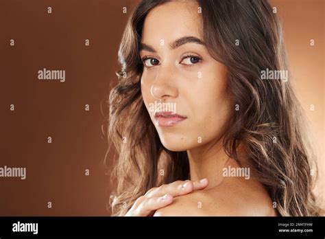 Woman, face skincare or curly hairstyle on studio background in ...