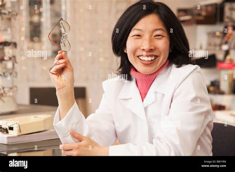 Korean optician holding eyeglasses Stock Photo - Alamy