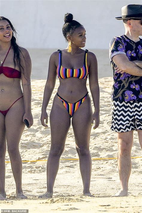 Janelle Monae showcases her flawless figure in a skimpy striped bikini as she frolics on the ...