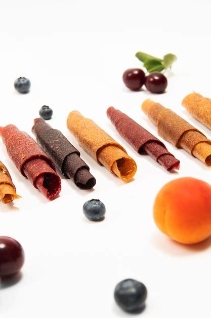 Premium Photo | Pattern pastila fruit leather rolls up with fruits on ...