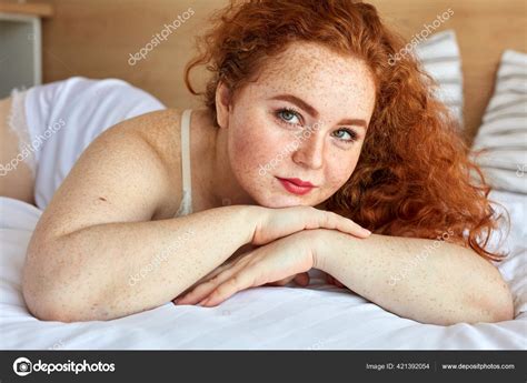 Red haired chubby woman in lingerie lies on bed, have rest Stock Photo ...