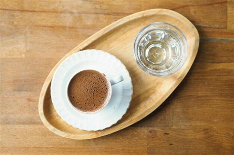 Premium Photo | A cup of turkish coffee and glass of water on table