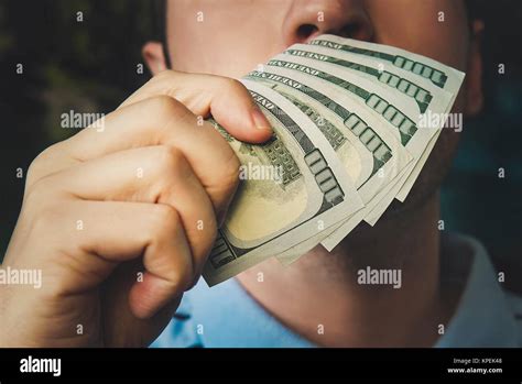 Handsome young businessman holding and smelling money. the smell of ...